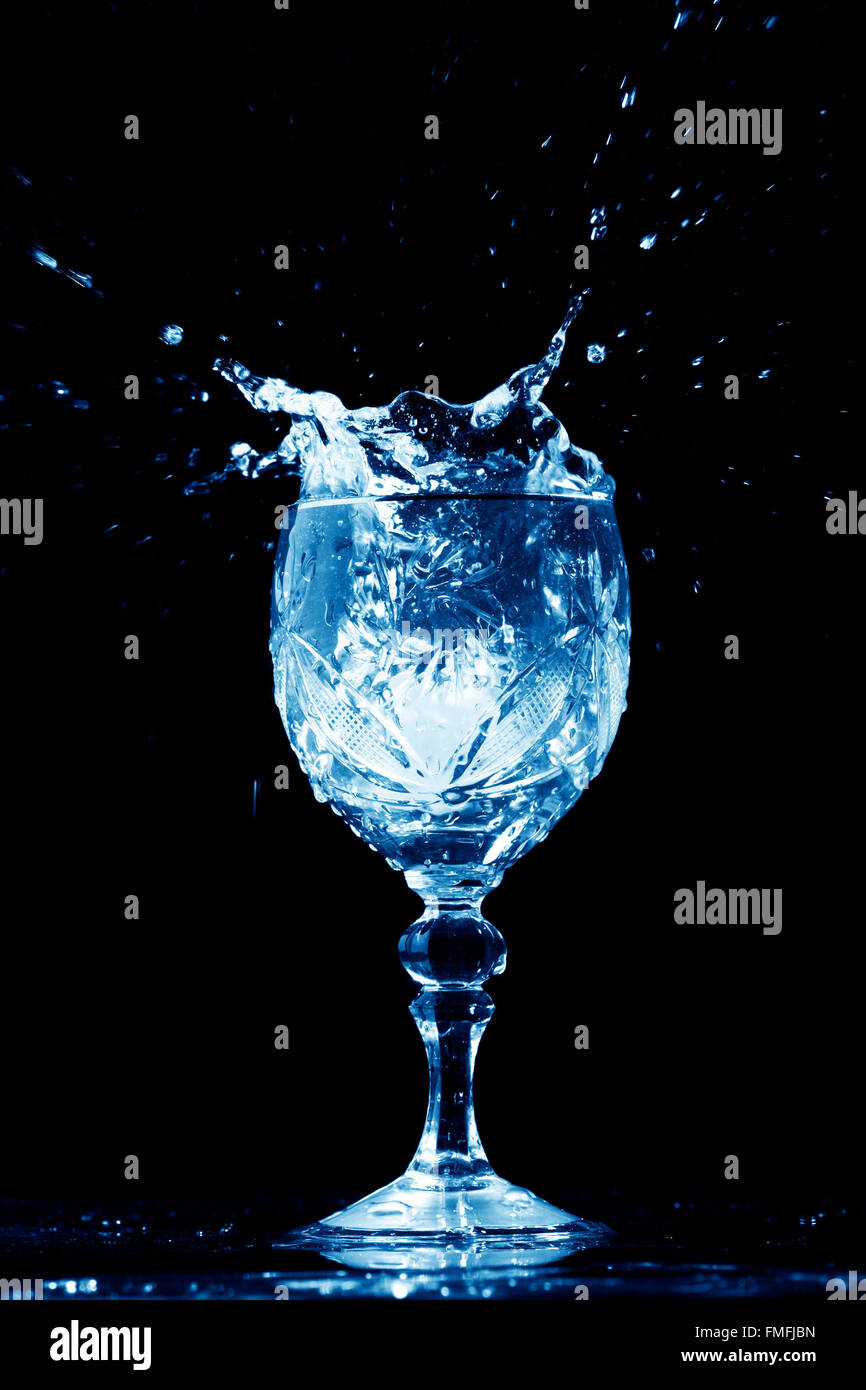 alcohol splash on black background Stock Photo - Alamy