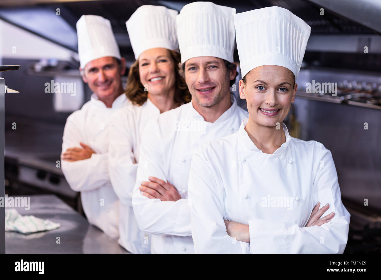 Happy chefs team standing together in commercial kitchen Stock Photo ...