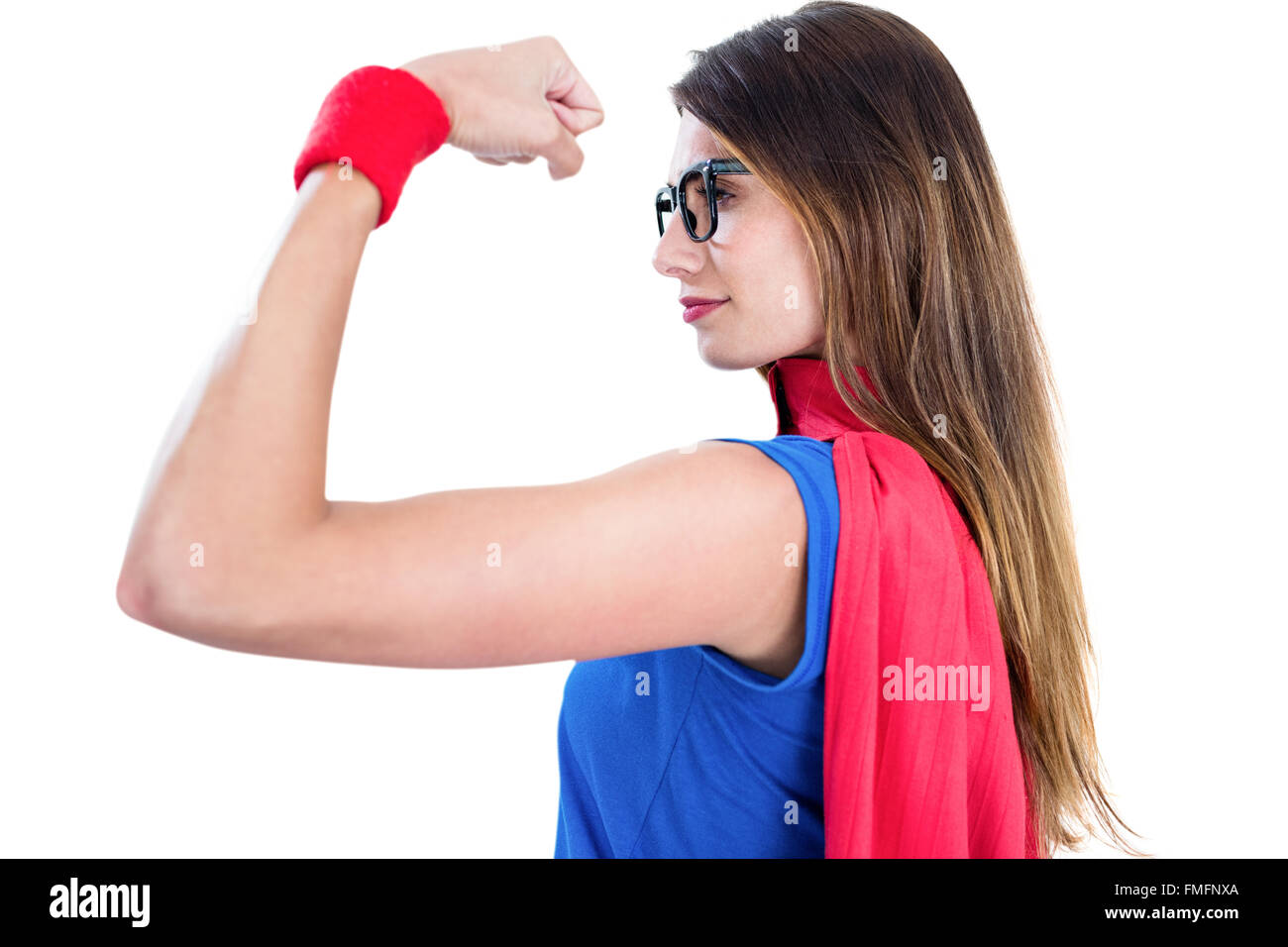 Woman in superhero costume while flexing muscles Stock Photo - Alamy