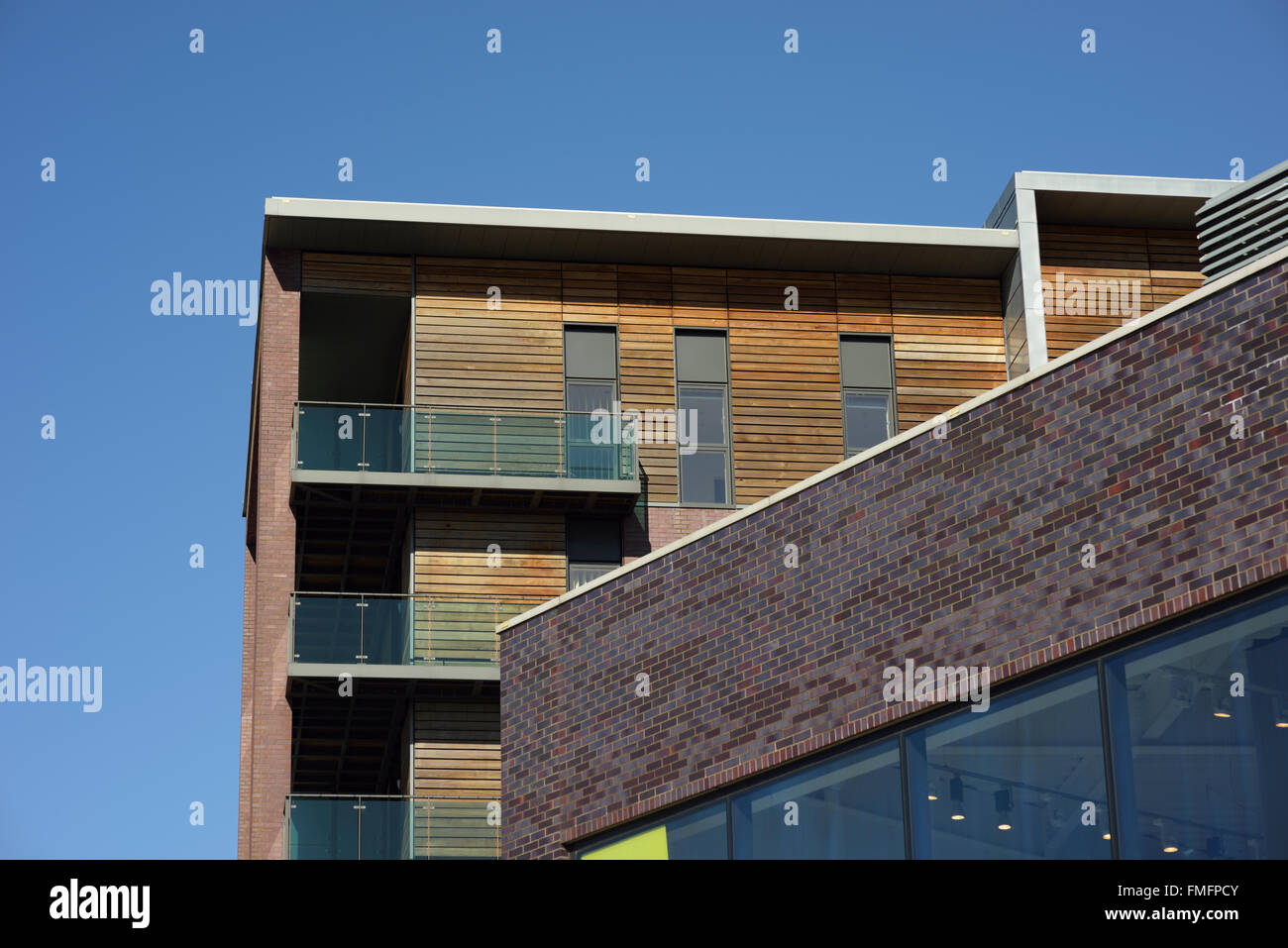 Apartments and blue sky with commercial building frontage in bury ...