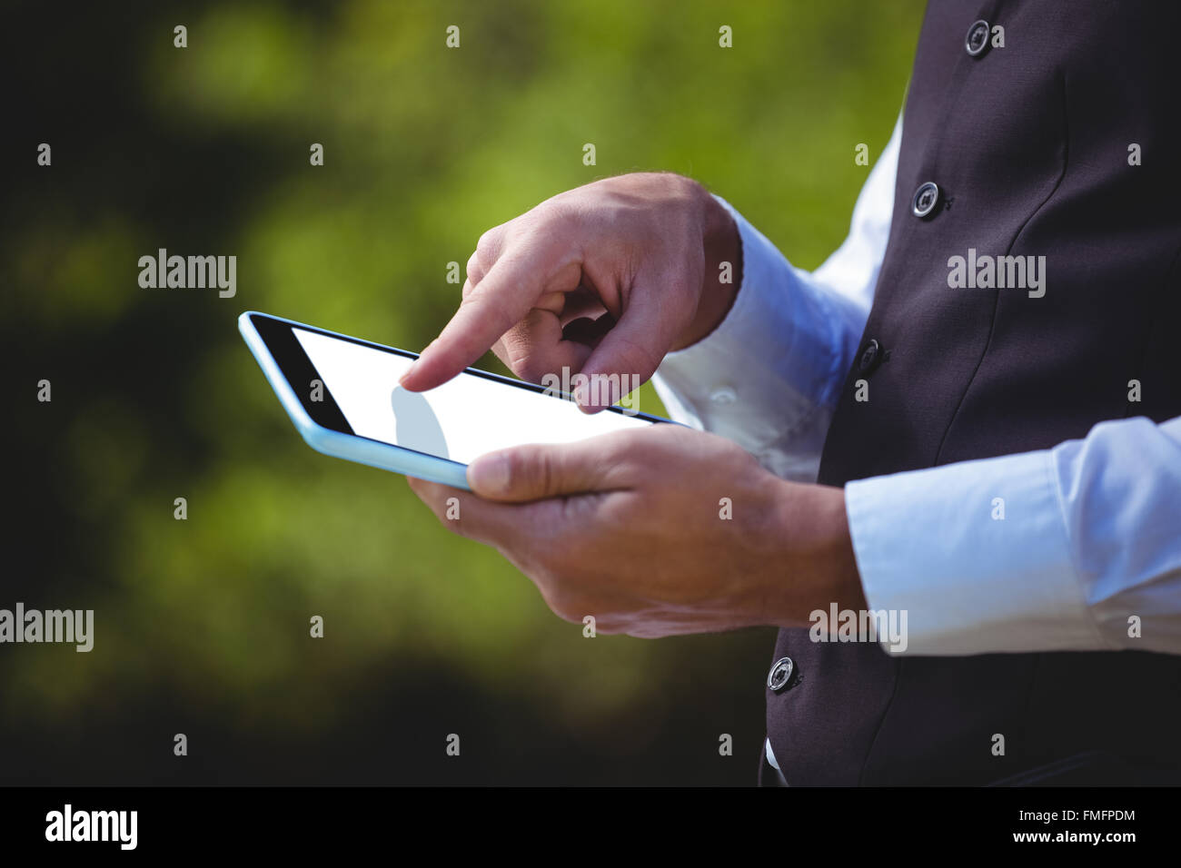 Handsome waiter using tablet computer Stock Photo - Alamy