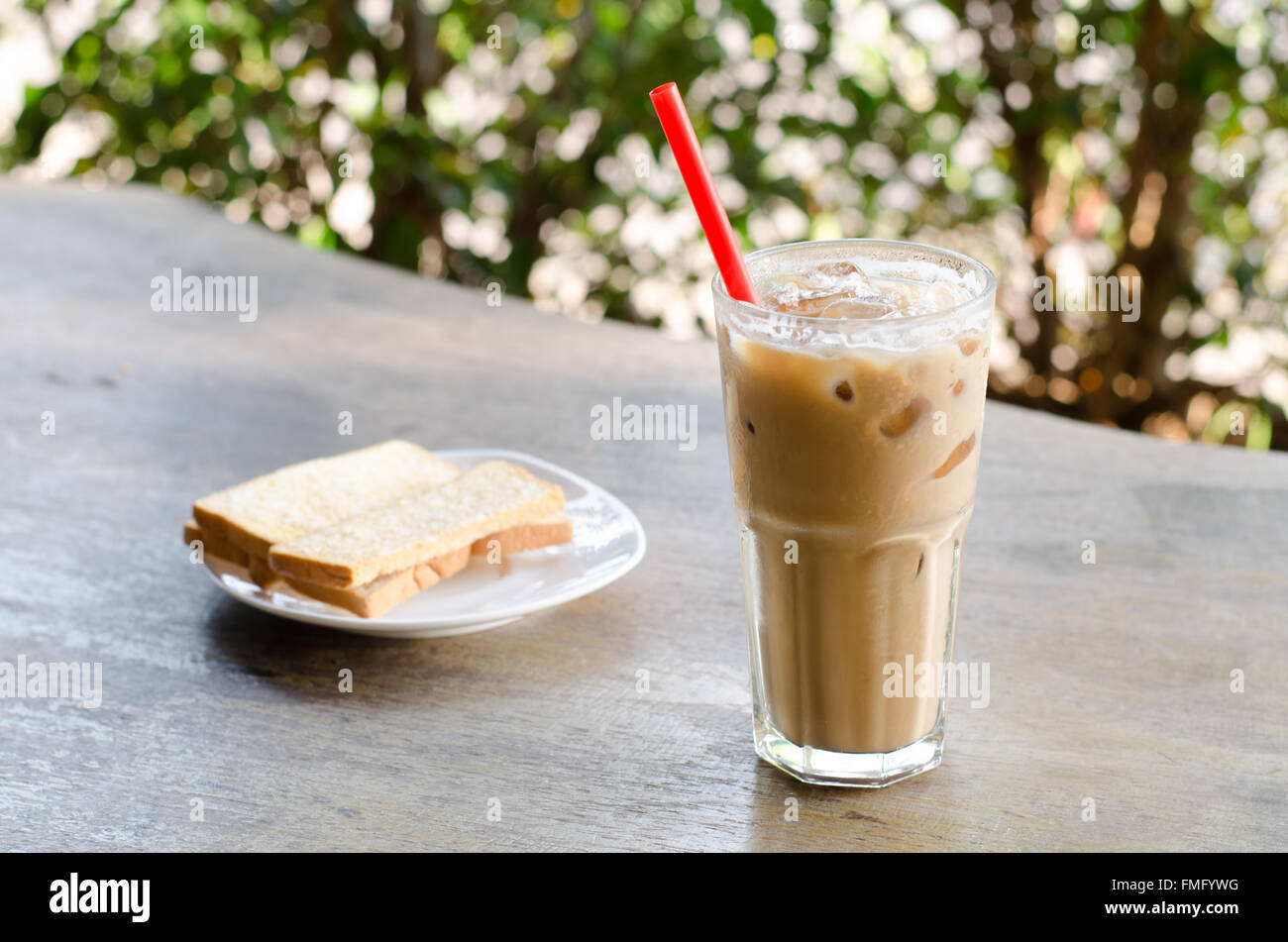 Glass Of Cold Coffee On Wood Table Stock Photo - Alamy