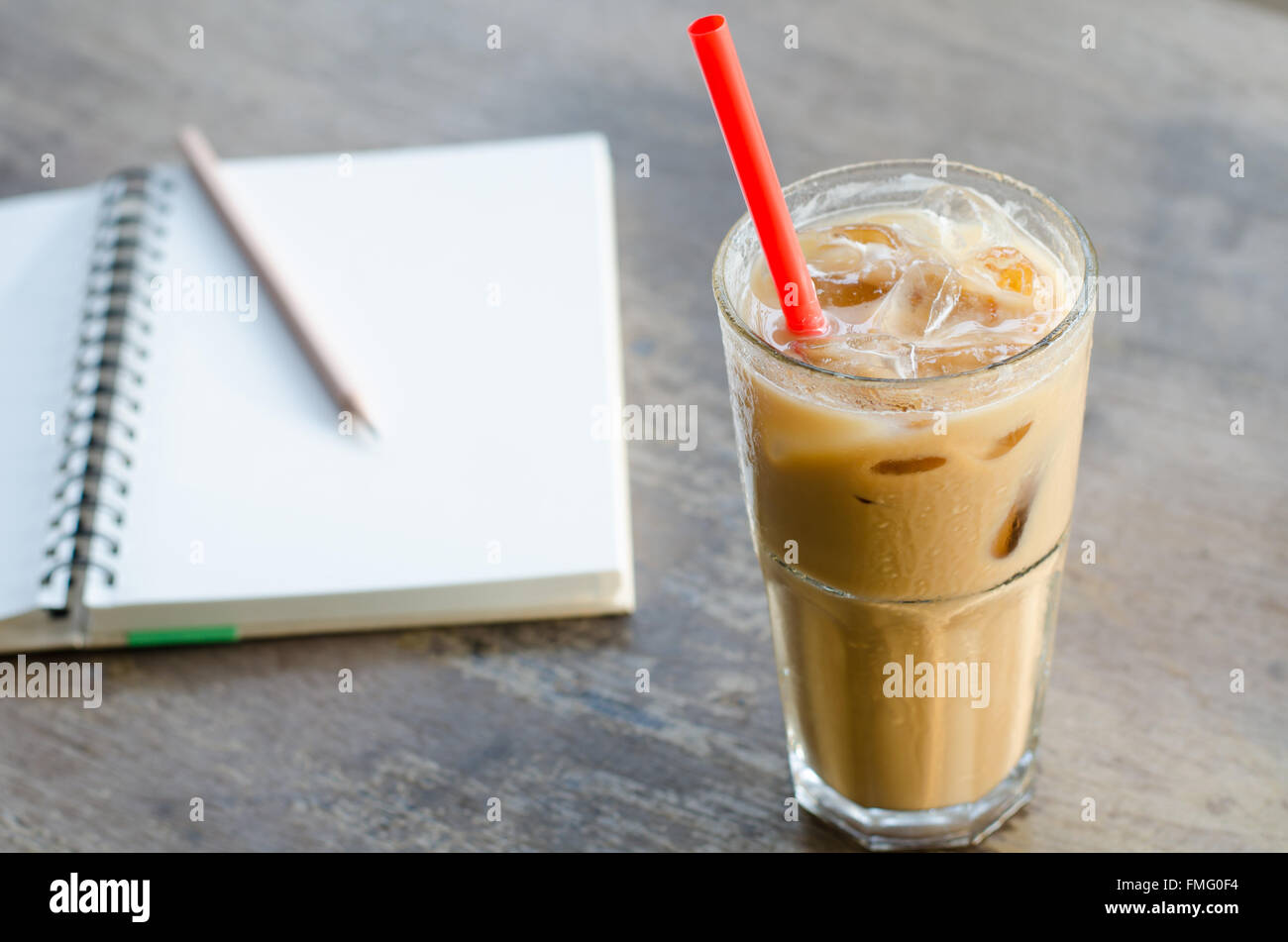 Glass Of Cold Coffee On Wood Table Stock Photo - Alamy
