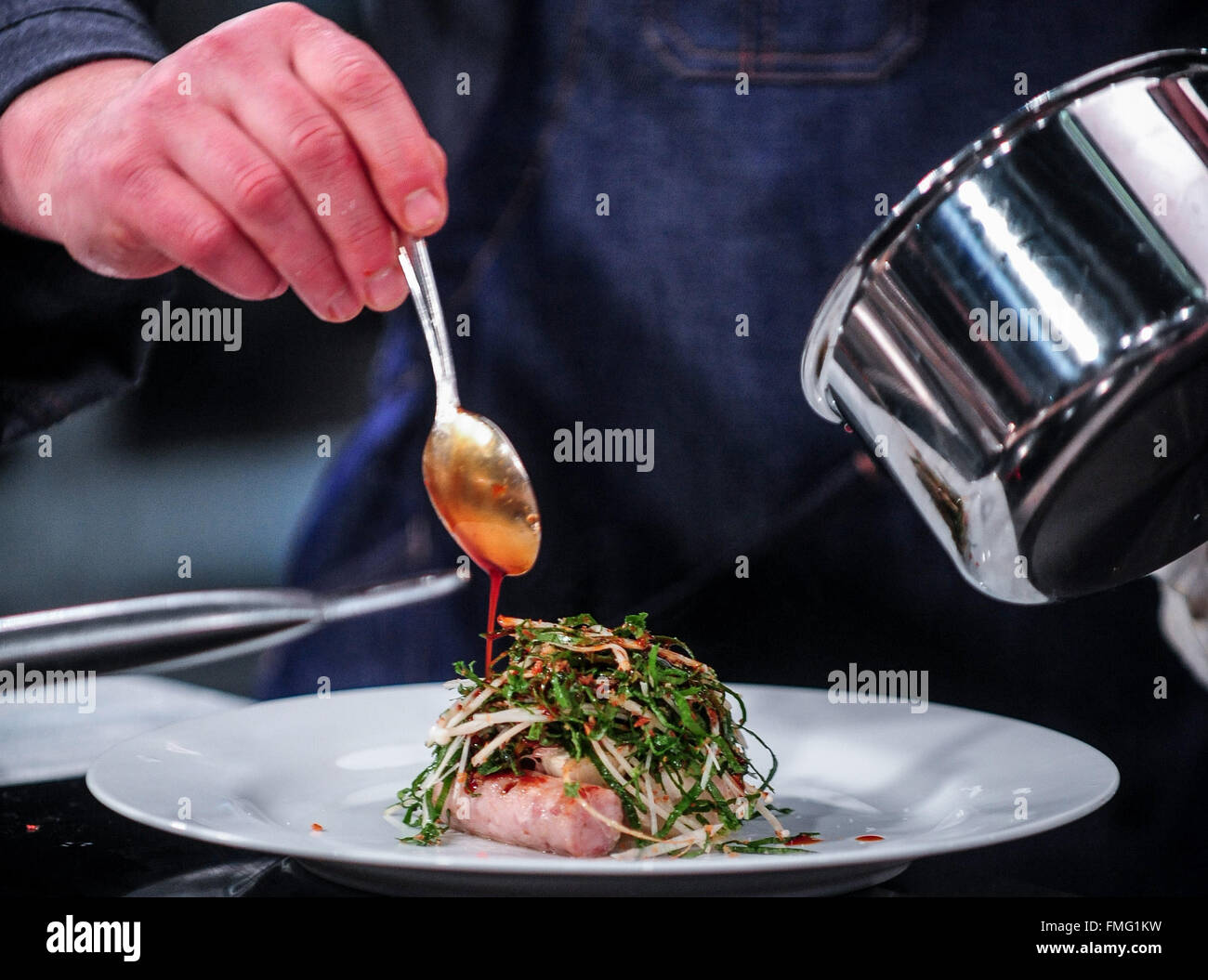 Los Angeles, USA. 11th Mar, 2016. A cook prepares food as six top chefs ...