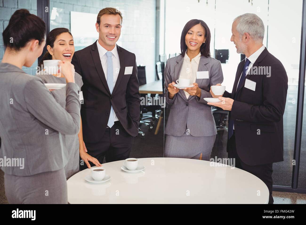 Businesspeople having a discussion during breaktime Stock Photo - Alamy