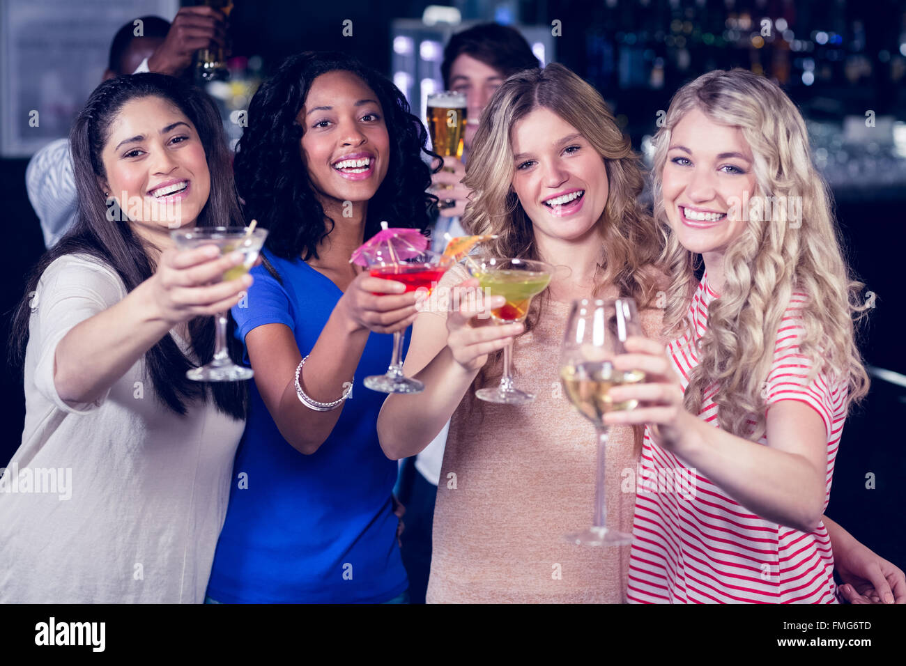 Friends drinking cocktails together Stock Photo - Alamy