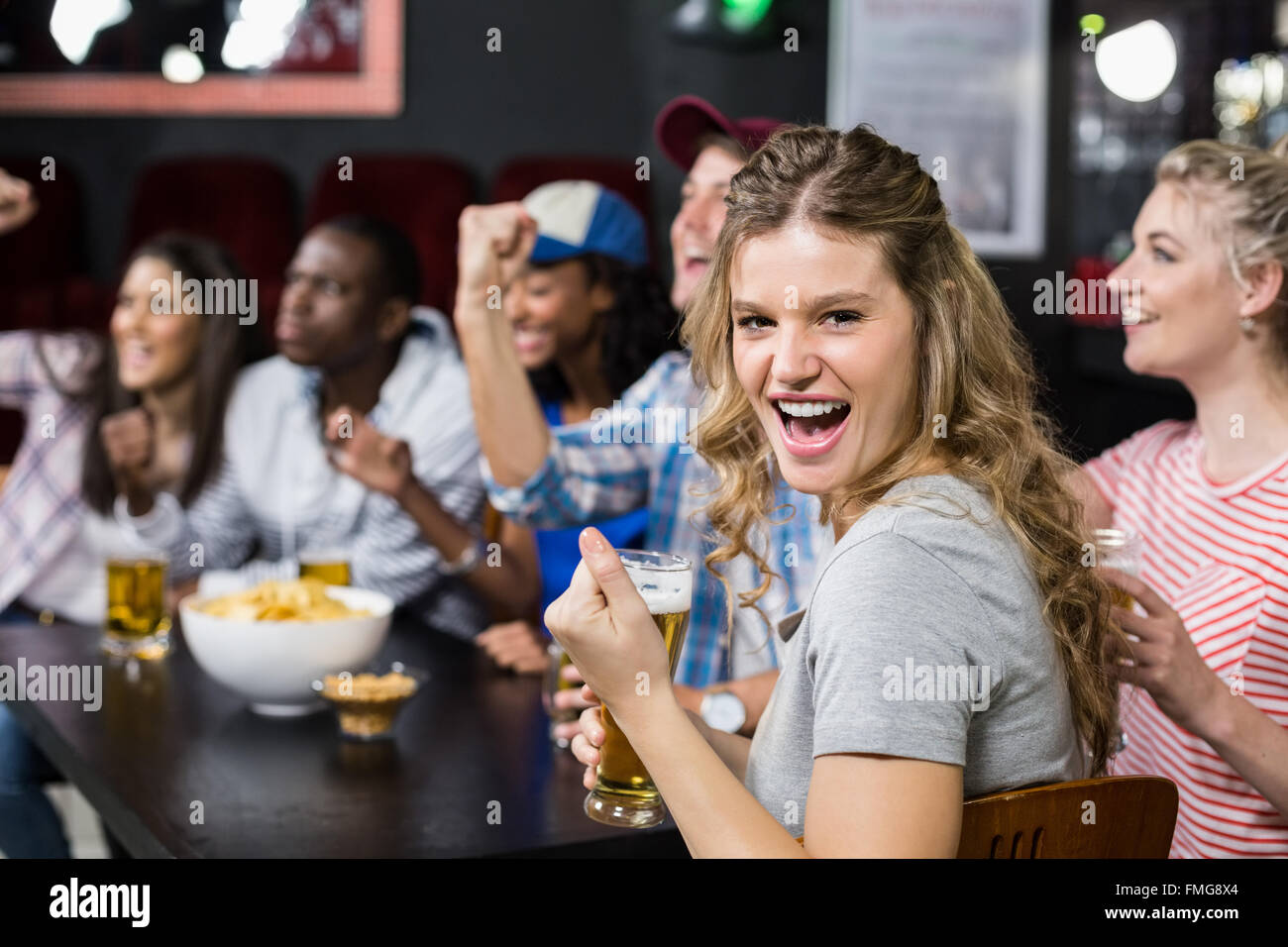 Happy friends watching sport Stock Photo - Alamy