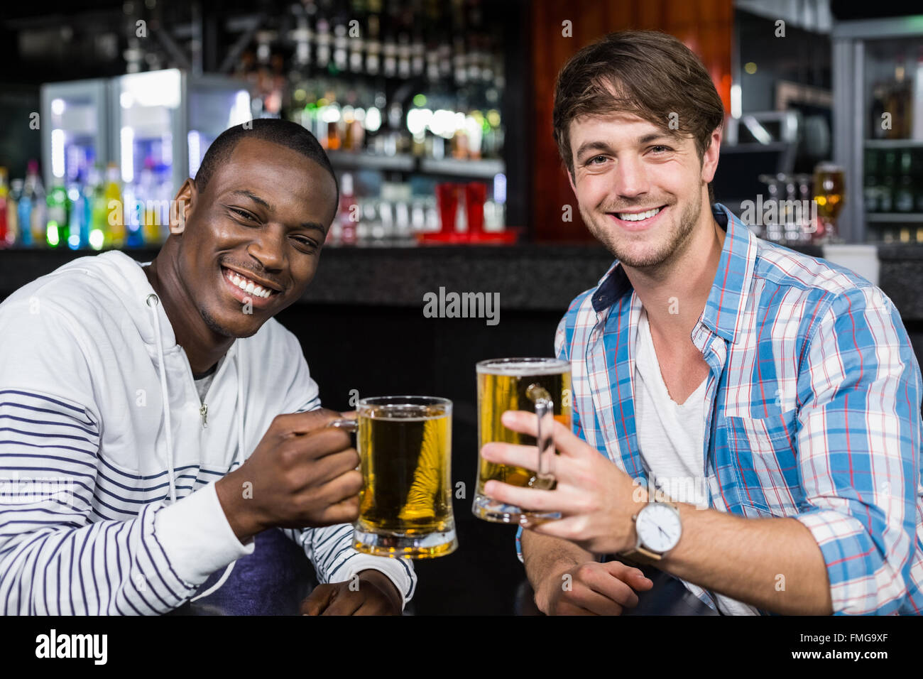 Happy friends having a drink Stock Photo - Alamy
