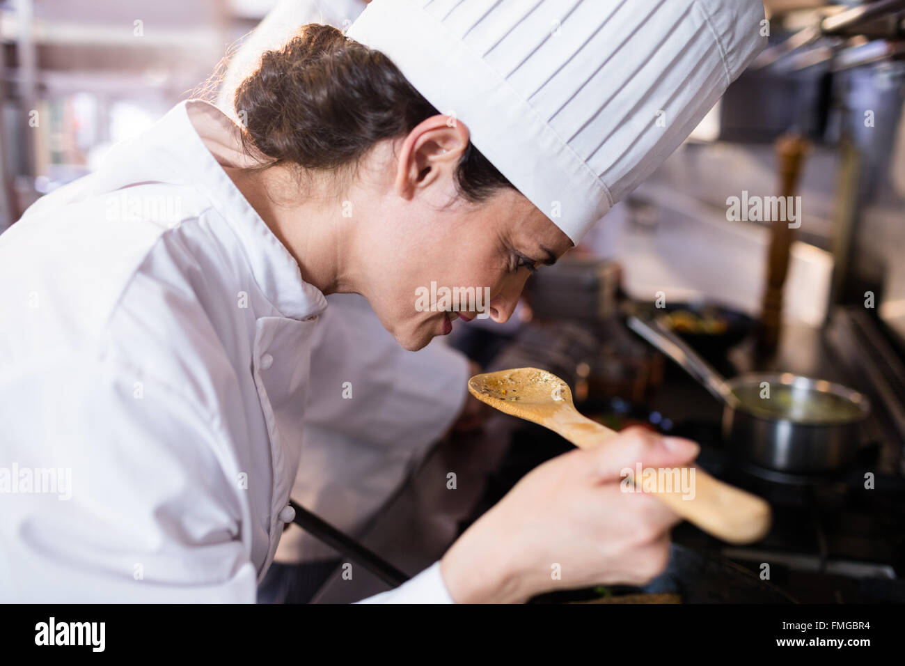 Chef smelling food in the kitchen Stock Photo - Alamy