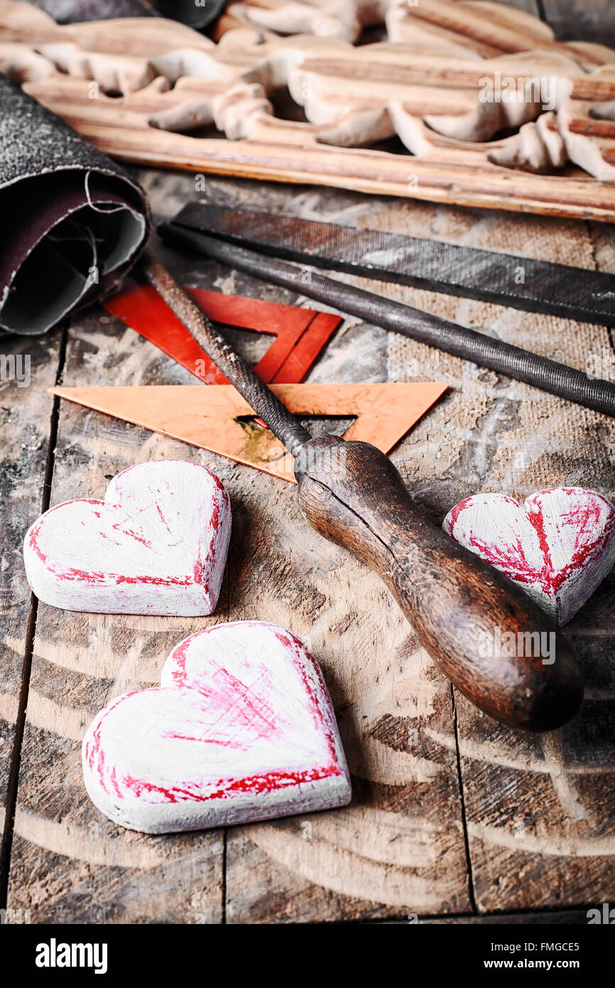 Symbolic wooden hearts cut by hand and carpenter tools Stock Photo - Alamy