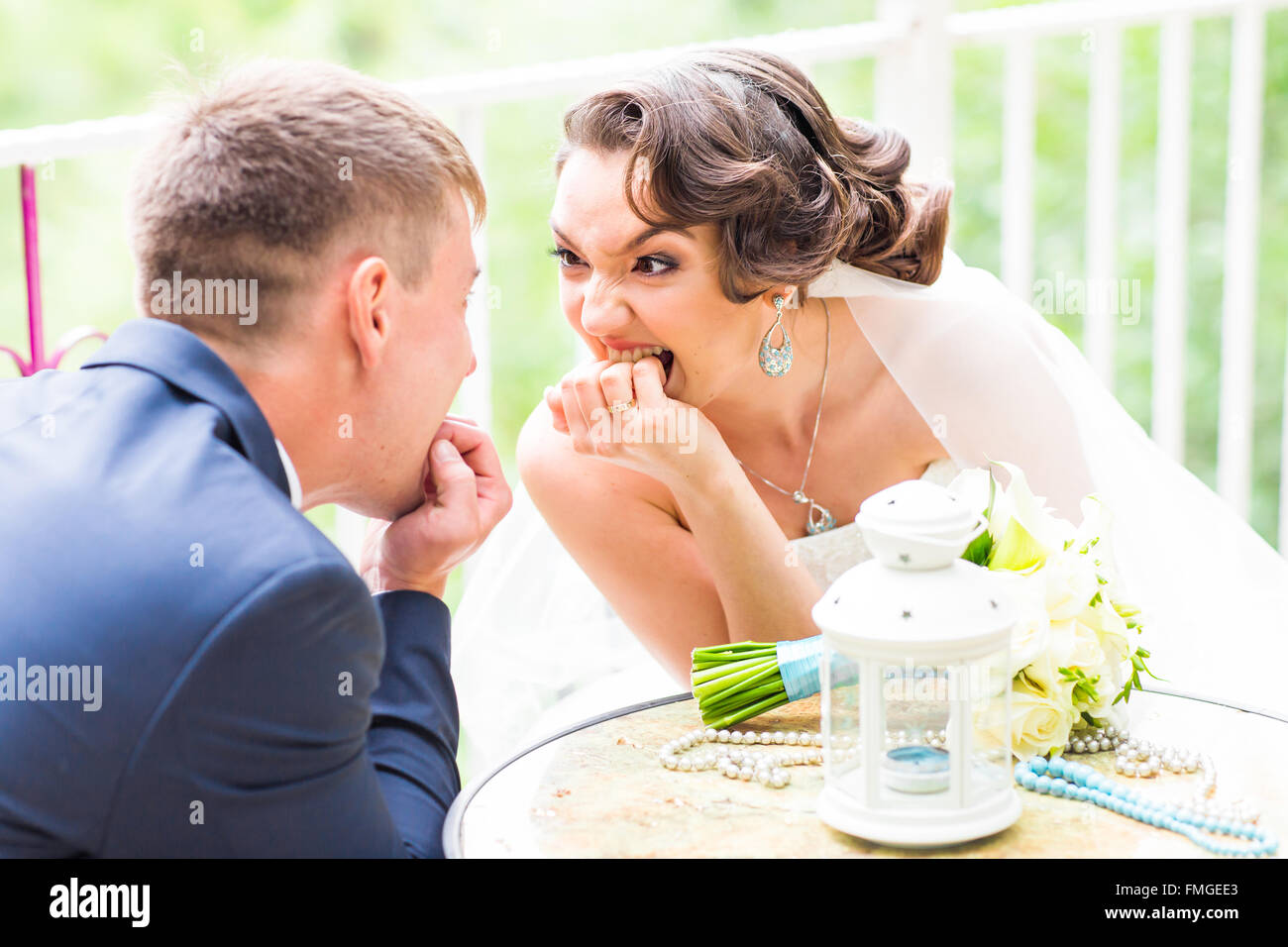 funny bride and crazy groom on the restaurant terrace Stock Photo - Alamy