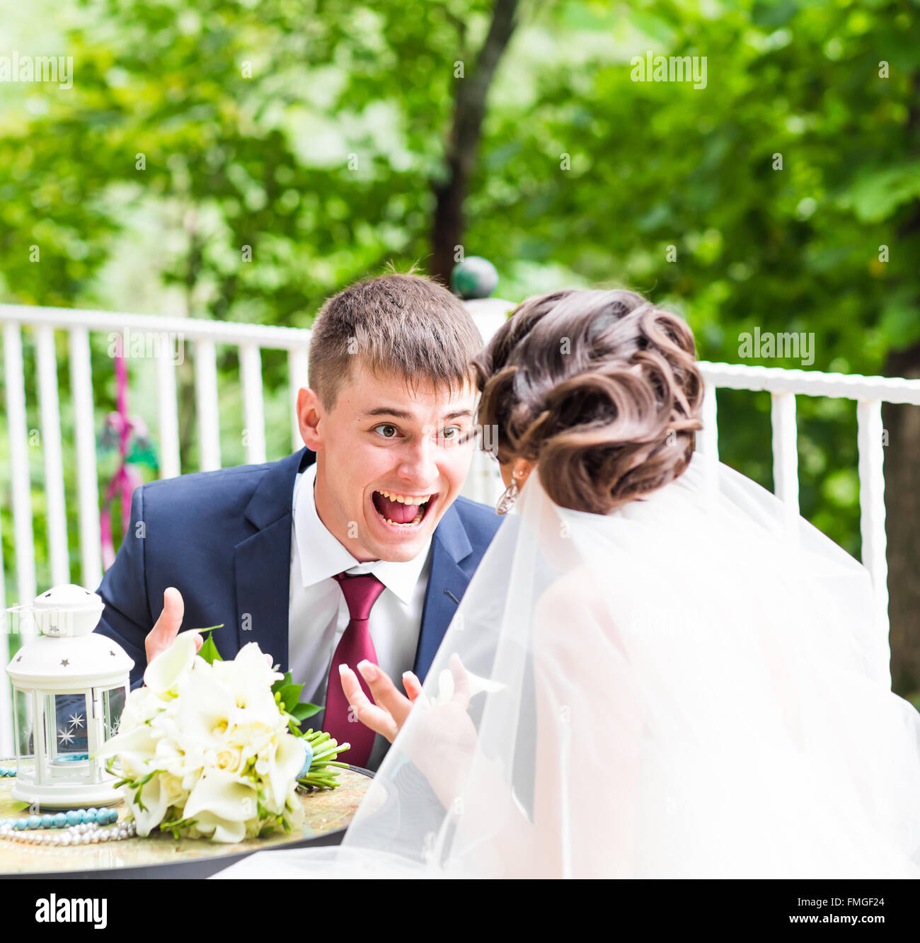 funny bride and crazy groom on the restaurant terrace Stock Photo - Alamy