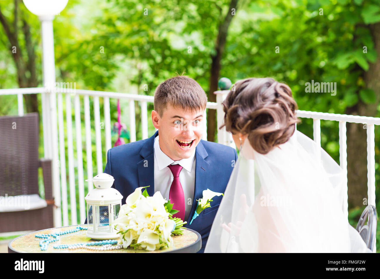 funny bride and crazy groom on the restaurant terrace Stock Photo - Alamy