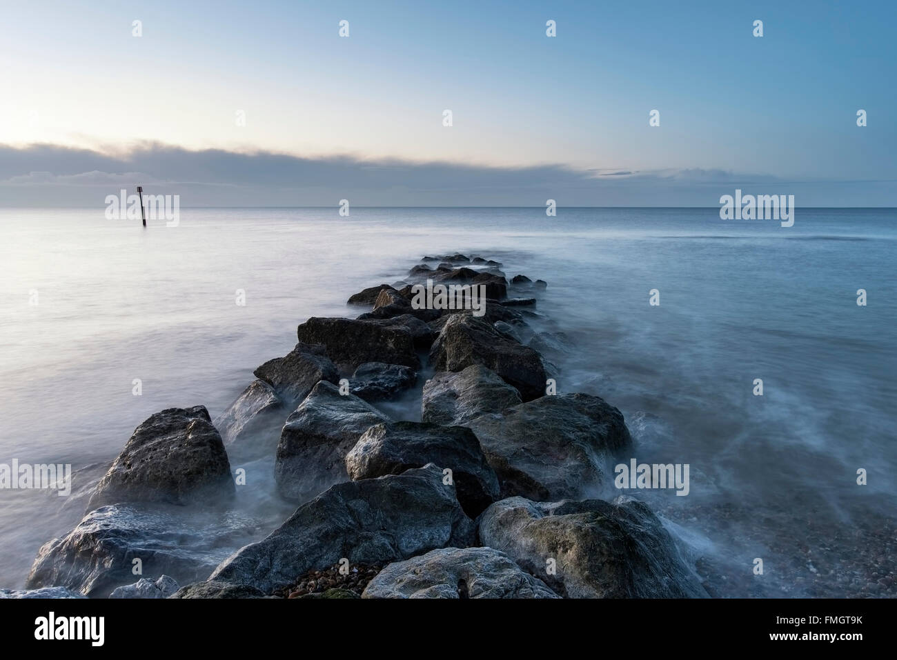Beautiful sunrise landscape over rocks in sea Stock Photo - Alamy