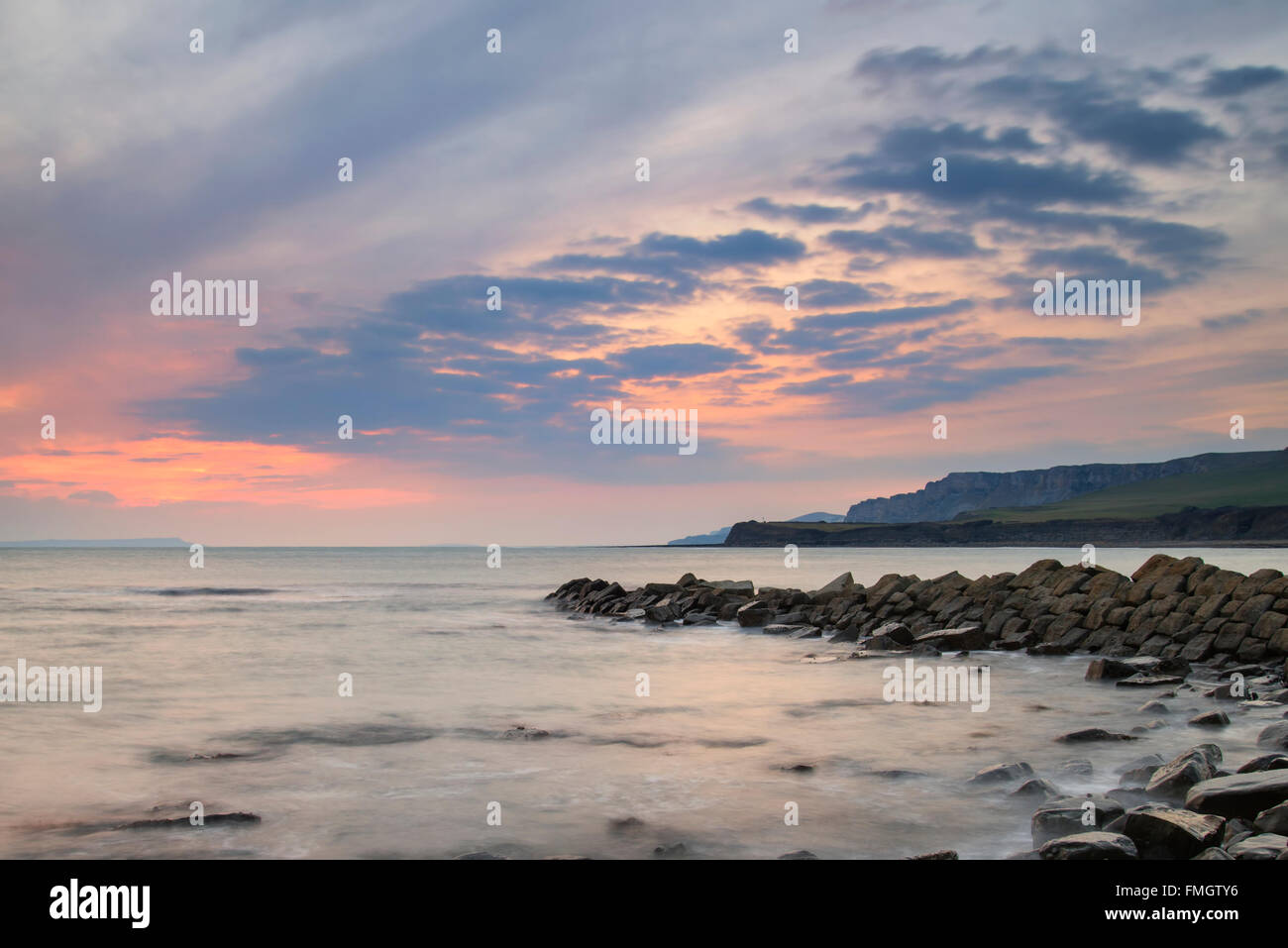 Stunning sunset landscape image of rocky coastline in Dorset England ...