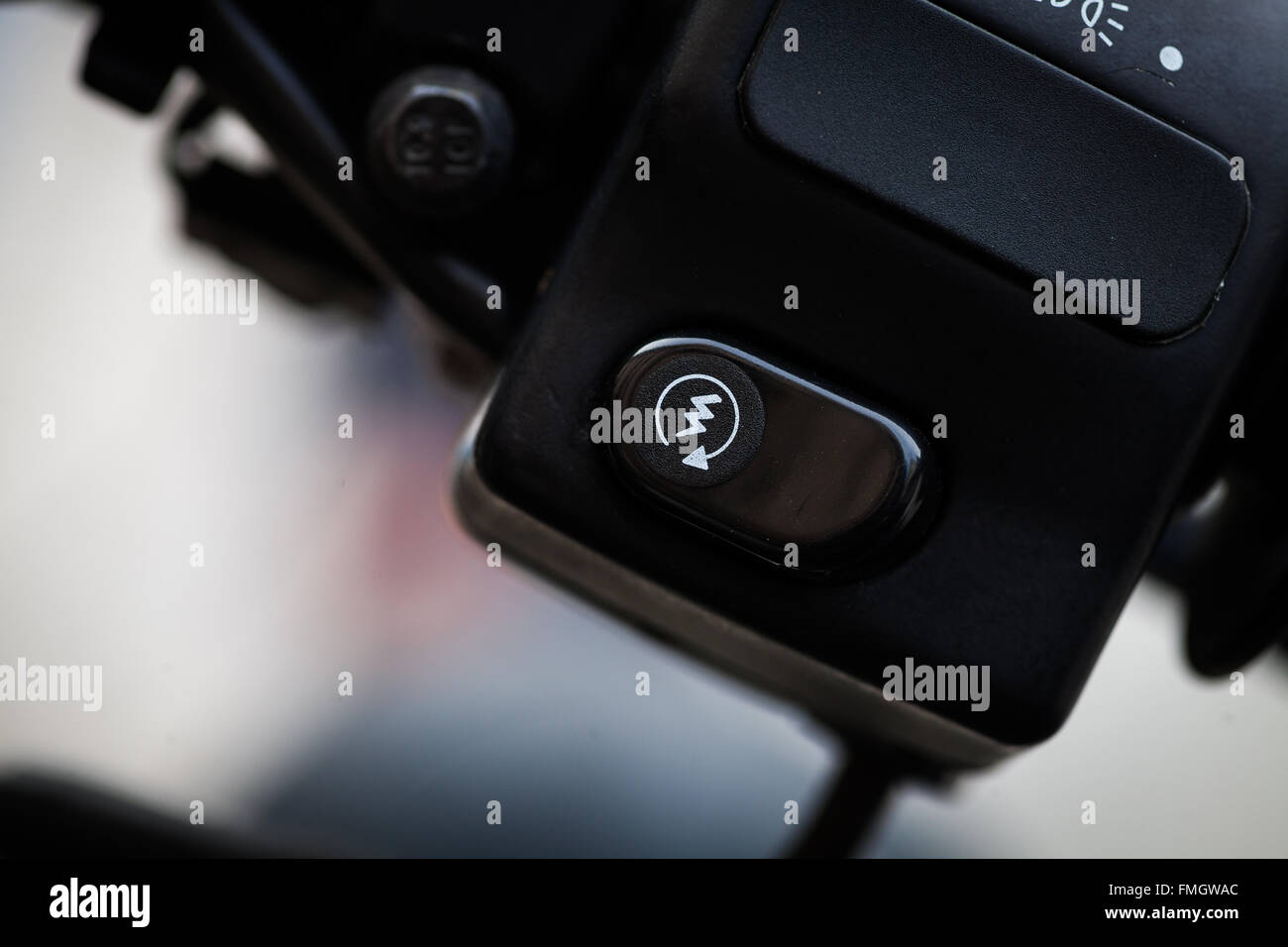 Color image of the ignition button of a motorcycle Stock Photo - Alamy