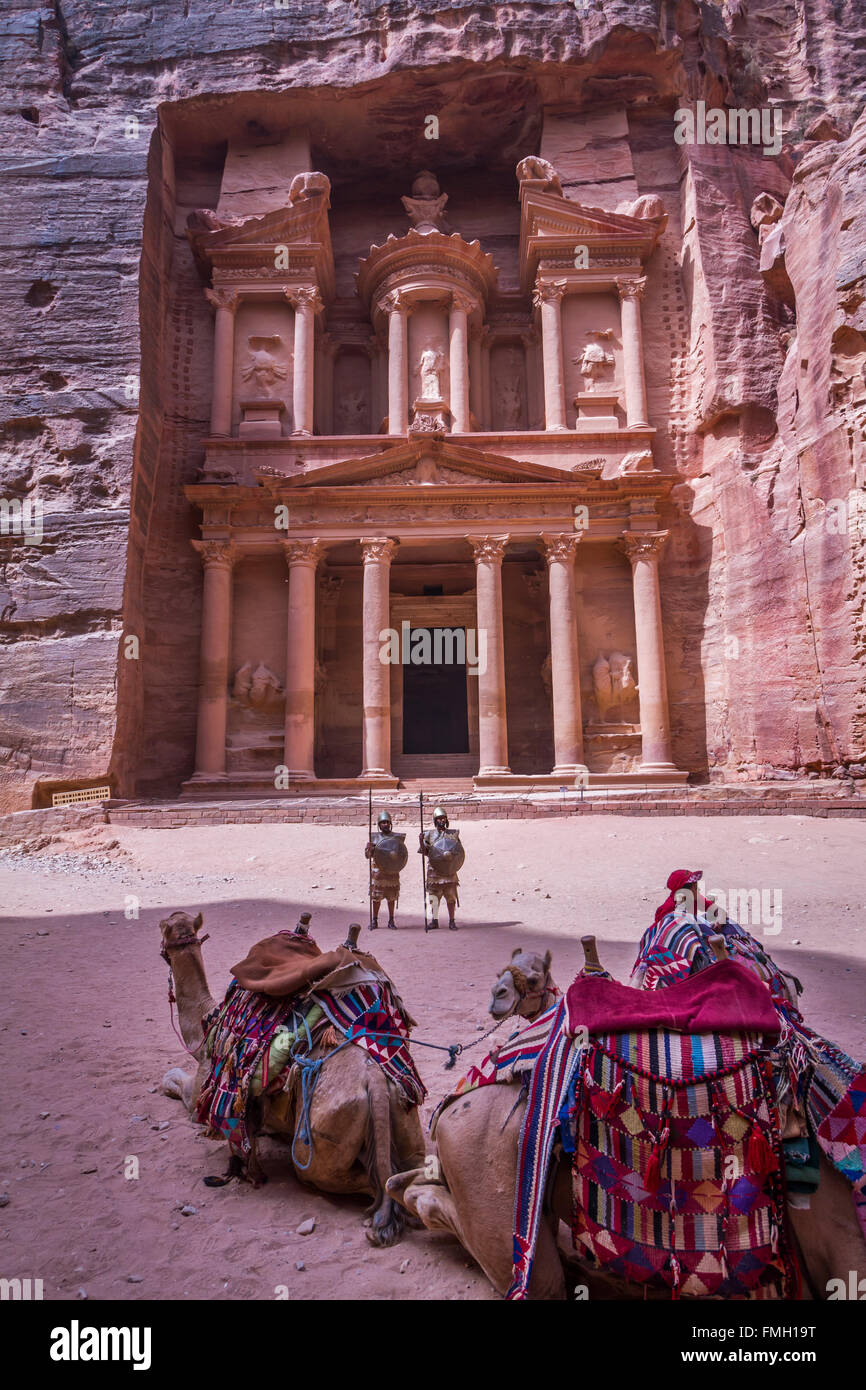 The Treasury building, Al Khazneh with camels in the red rock ruins of ...