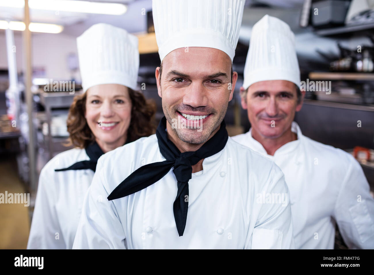 Team of chefs smiling in commercial kitchen Stock Photo - Alamy