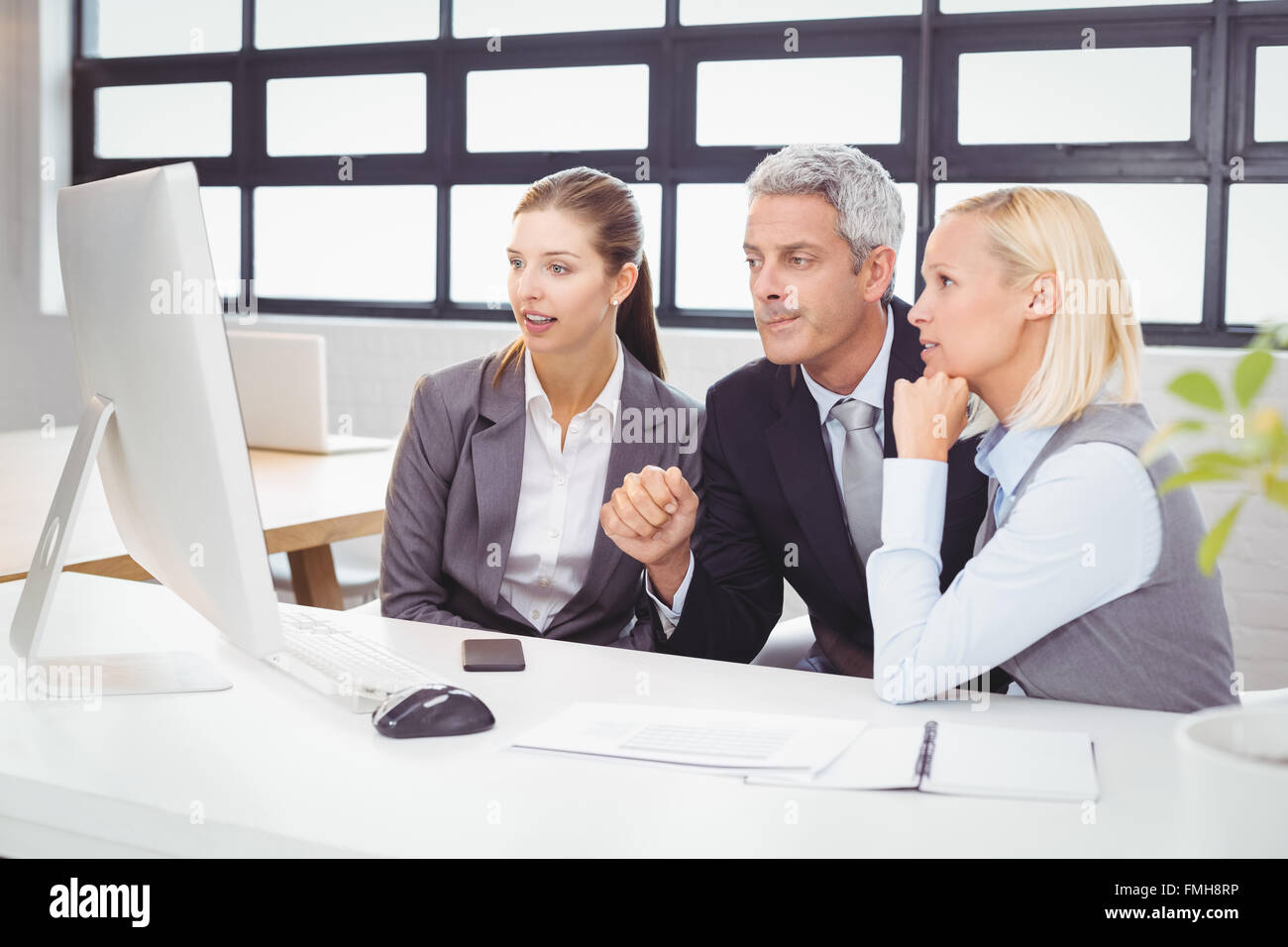 Business professionals working at computer desk Stock Photo - Alamy