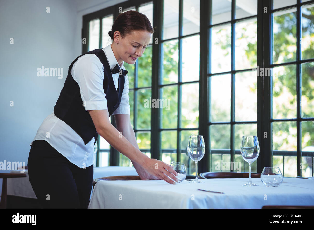 Waitress setting the table Stock Photo - Alamy
