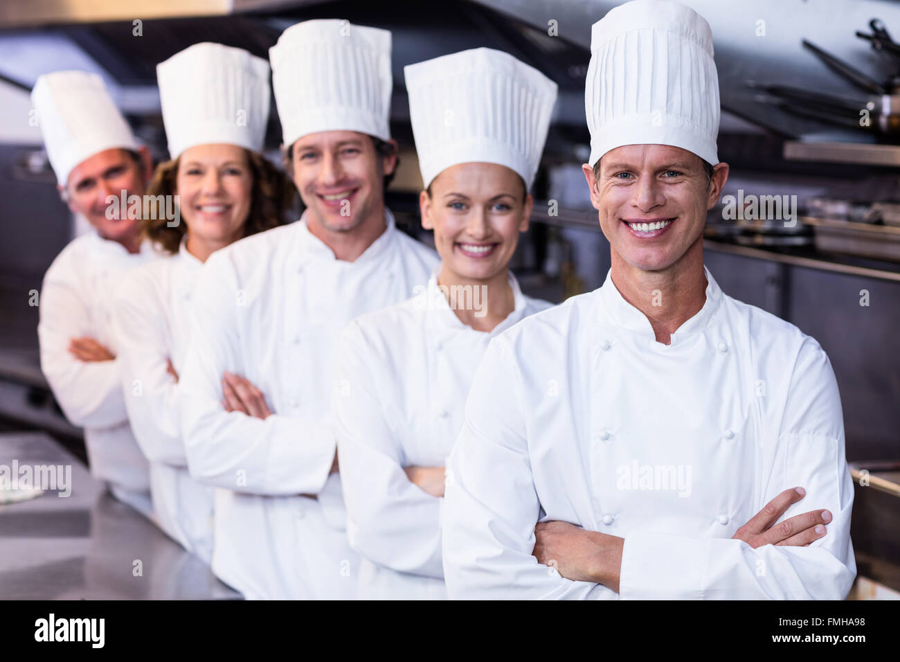 Happy chefs team standing together in commercial kitchen Stock Photo ...