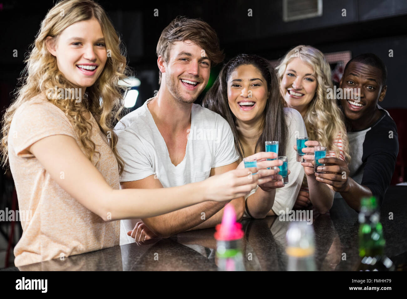 Group of friends having shots Stock Photo - Alamy