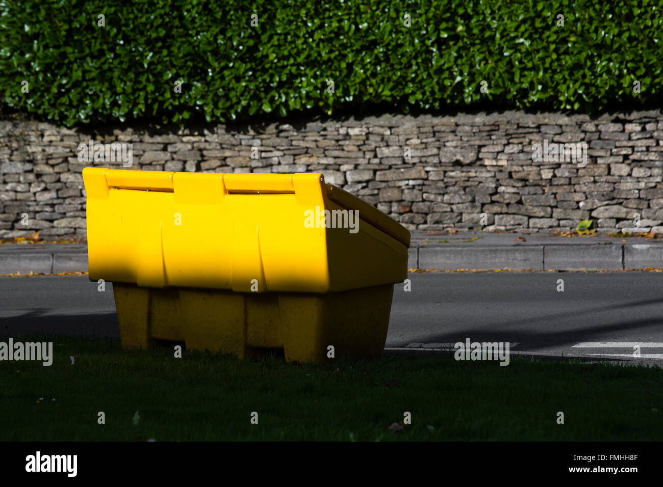 A large yellow bin for salt and grit on the side of a road Stock Photo ...