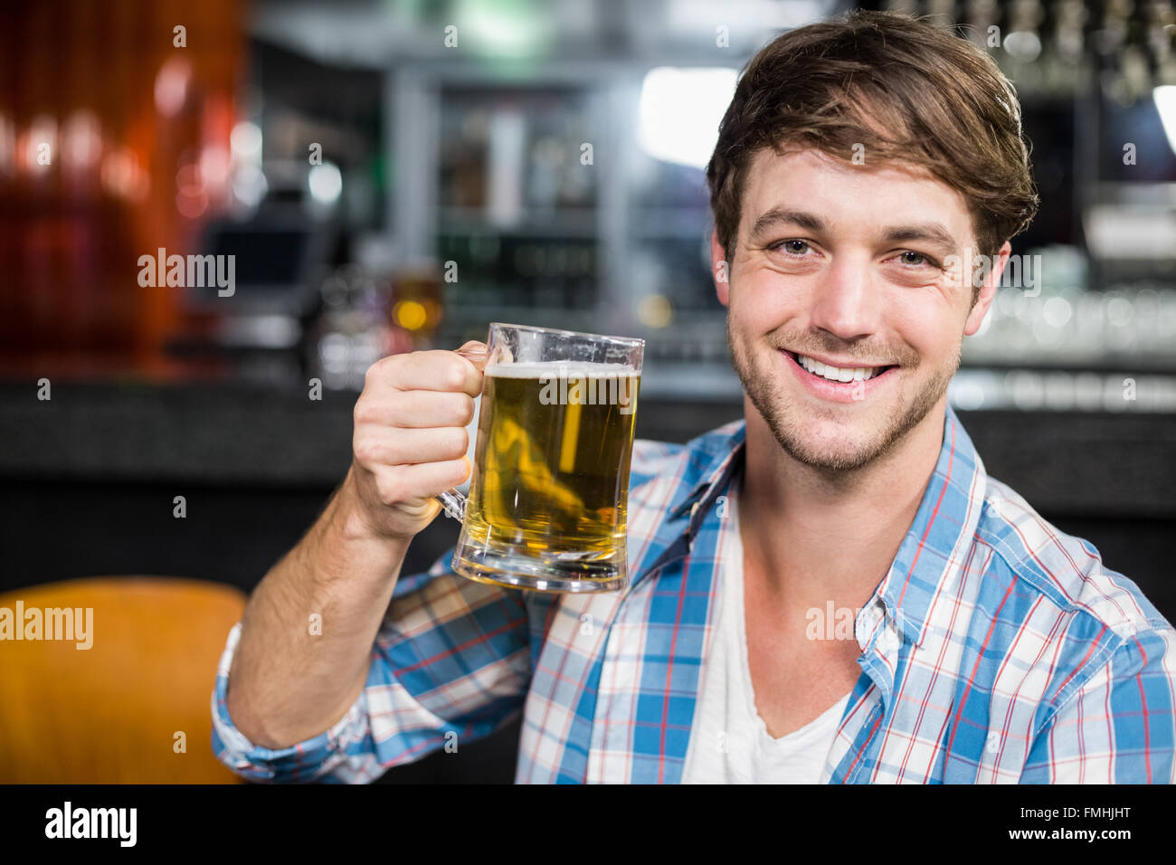 Portrait of smiling man drinking a beer Stock Photo - Alamy