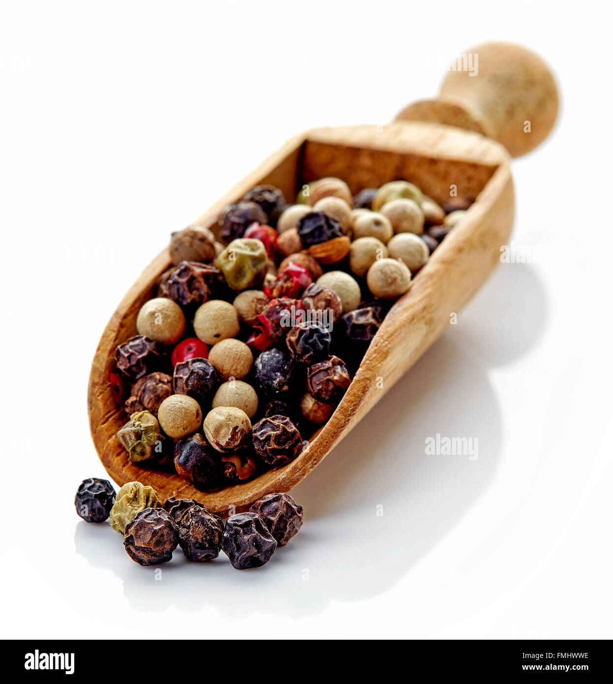 Five peppers in wooden shovel isolated on white background Stock Photo ...