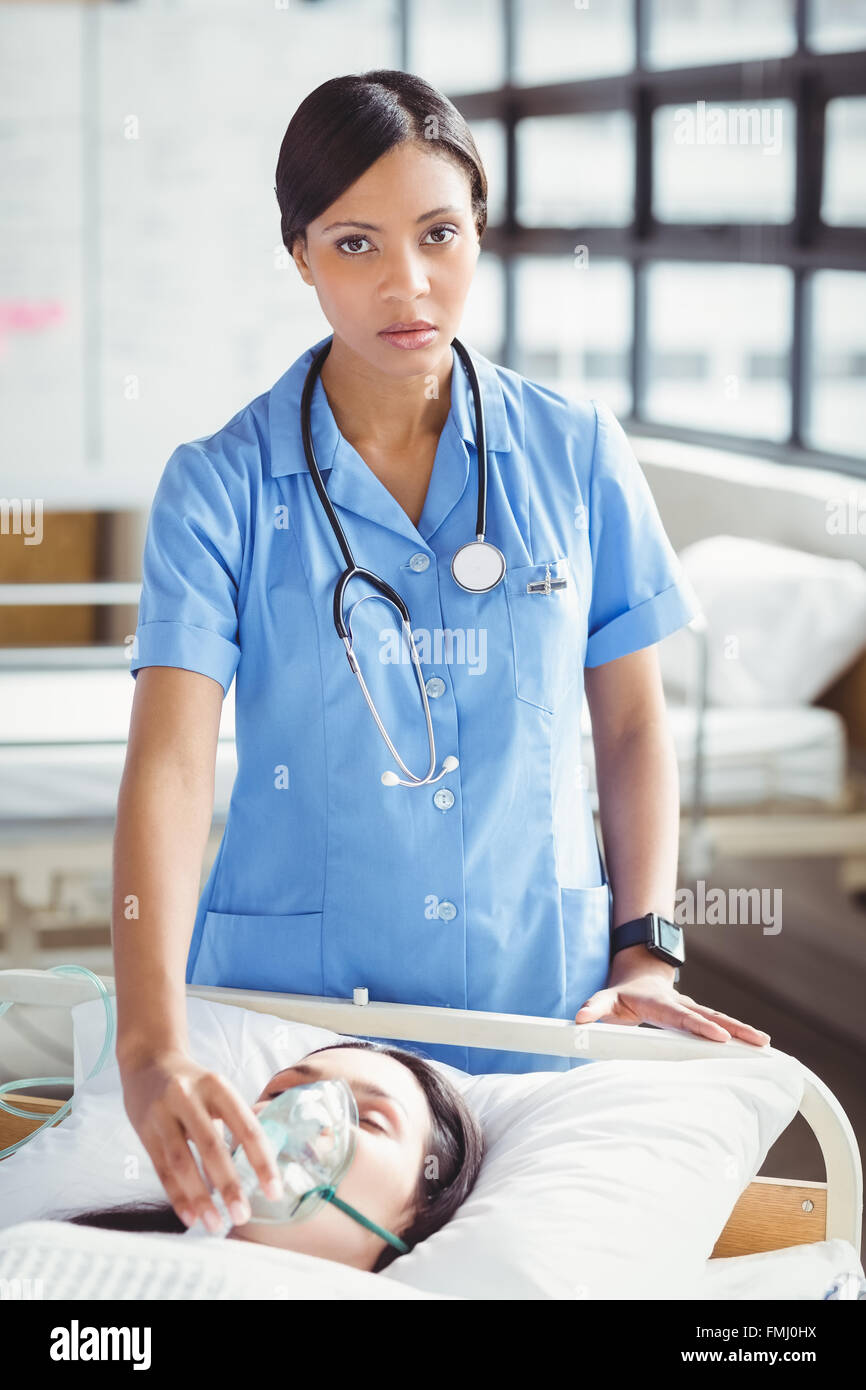 Nurse putting oxygen mask on a female patient Stock Photo - Alamy