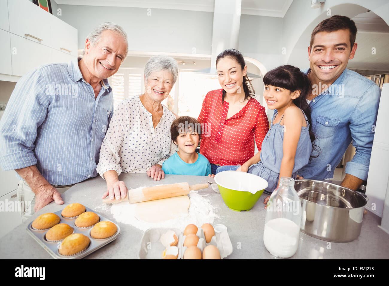 Portrait of happy family making bread in kitchen Stock Photo - Alamy