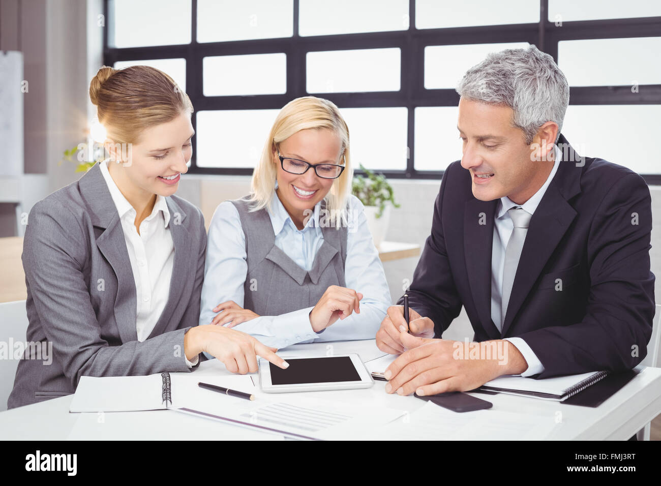 Business people discussing with client over digital tablet Stock Photo ...