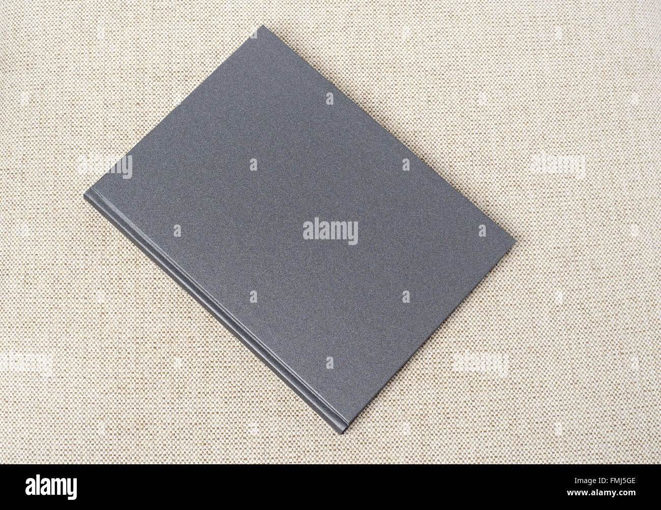 Grey book on the sofa Stock Photo - Alamy
