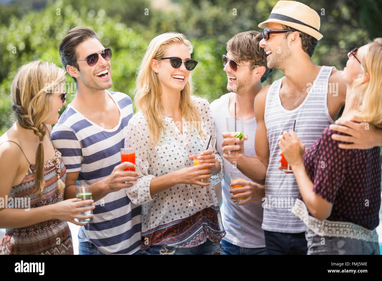 Group of happy friends having juice Stock Photo - Alamy