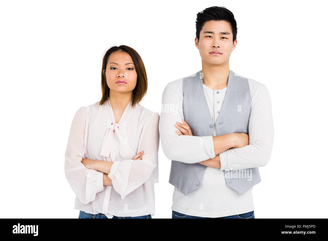 Upset couple standing with arms crossed Stock Photo - Alamy