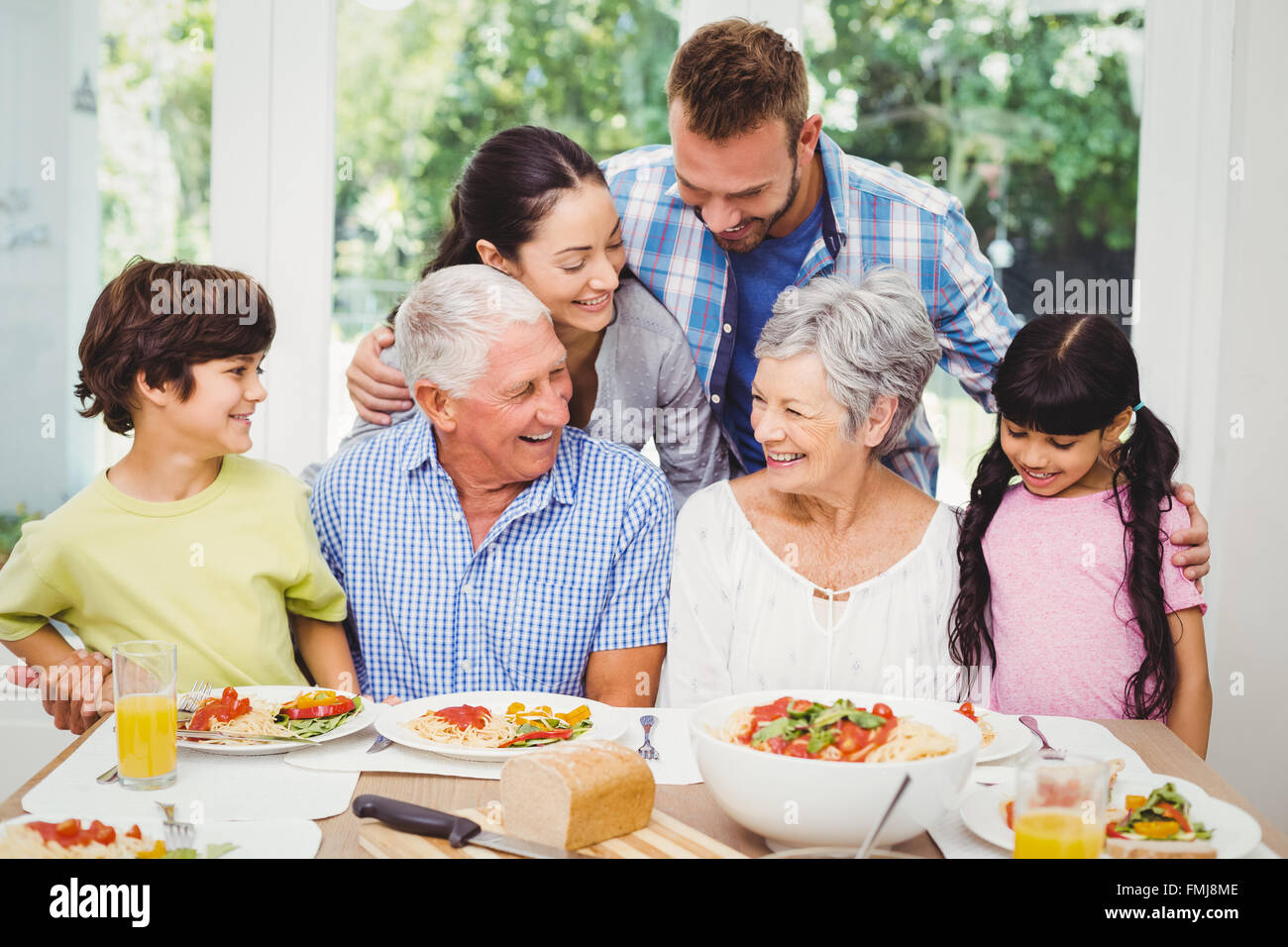 Multi generation family discussing at dining table Stock Photo - Alamy