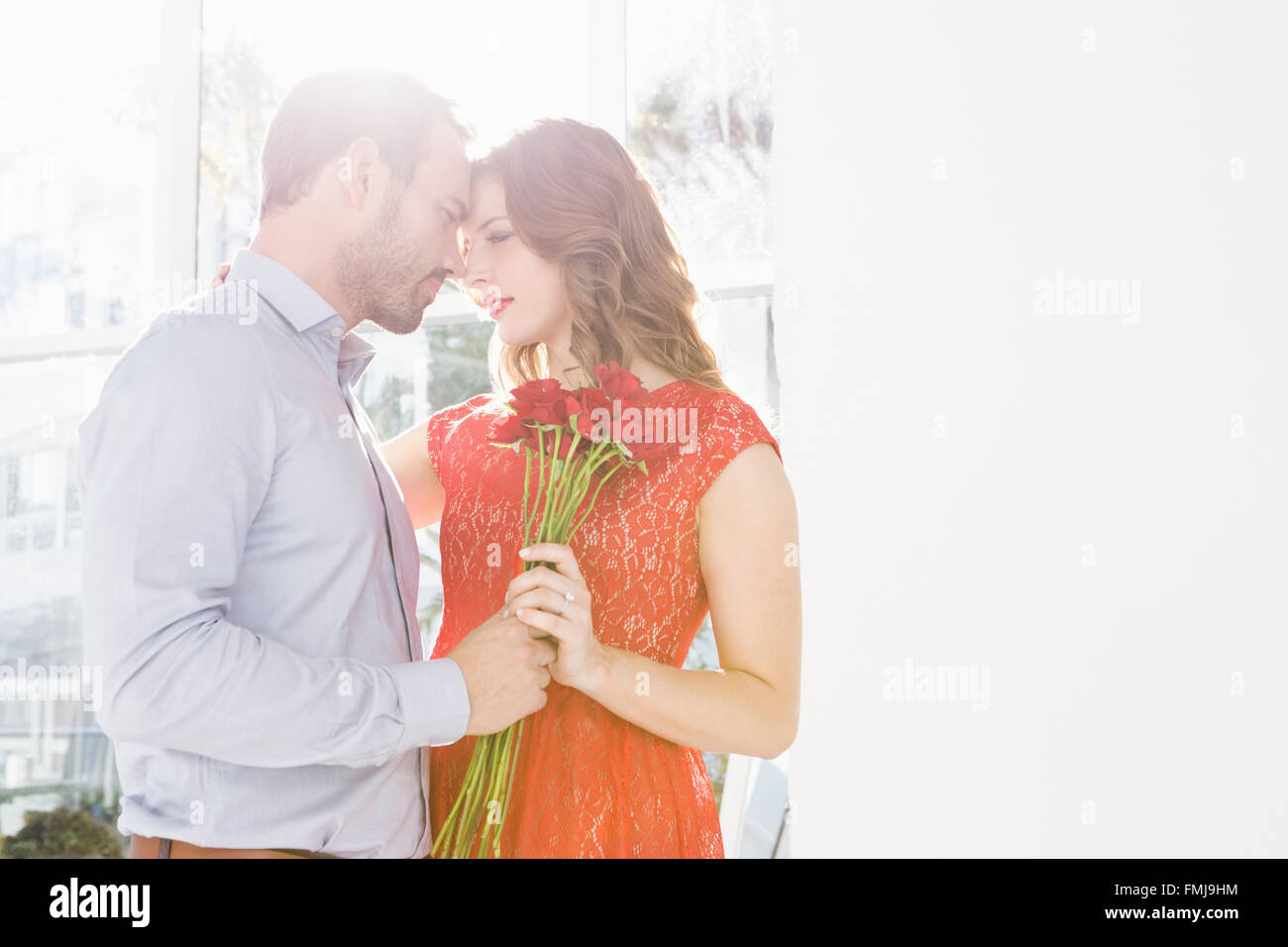 Man offering flower bouquet to woman Stock Photo - Alamy