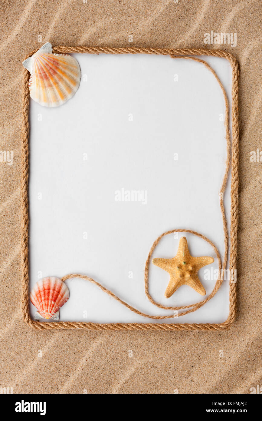 Beautiful frame of rope and star and sea shells with a white background ...