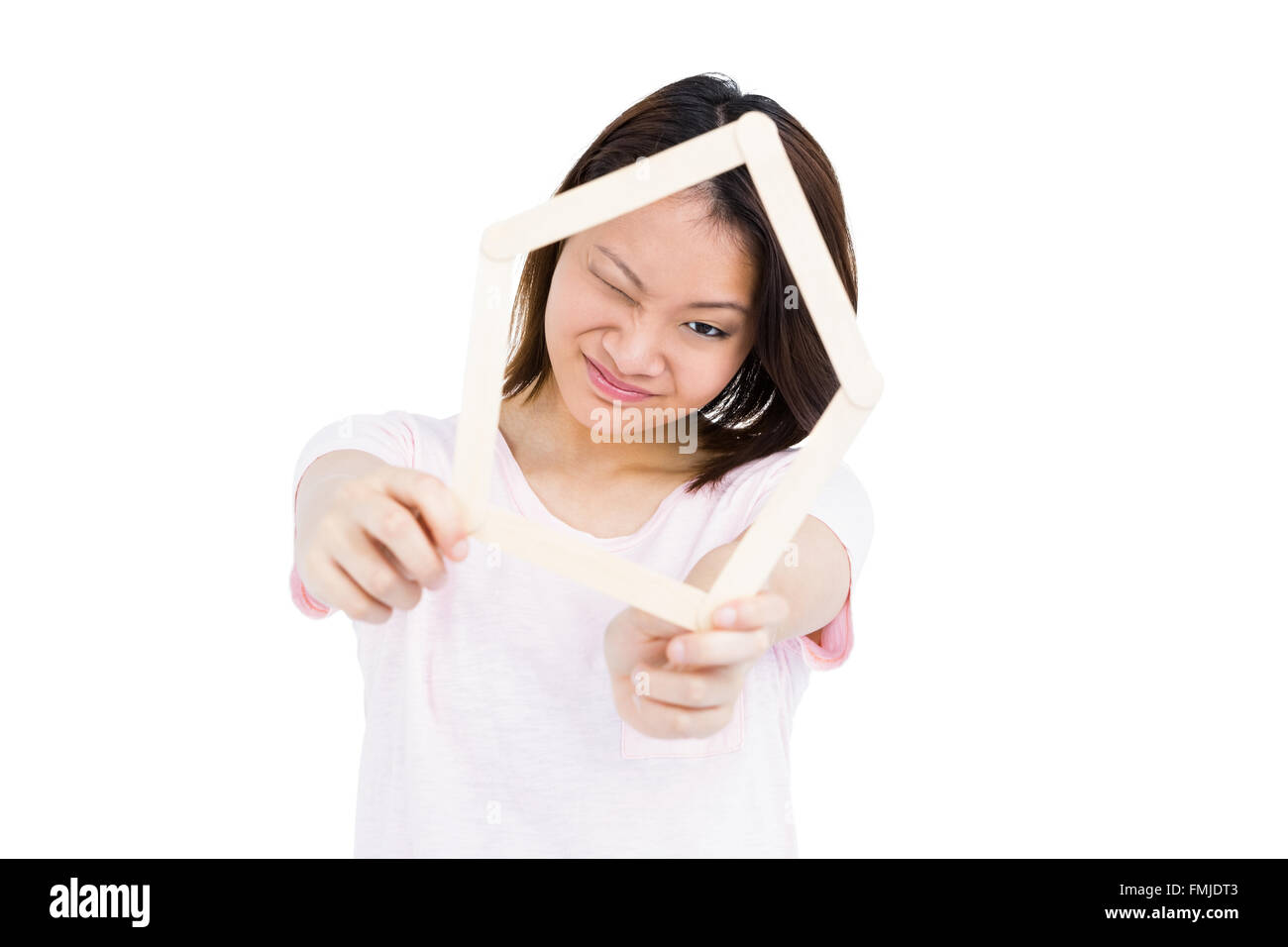 Young woman holding house shaped popsicle sticks on face Stock Photo ...