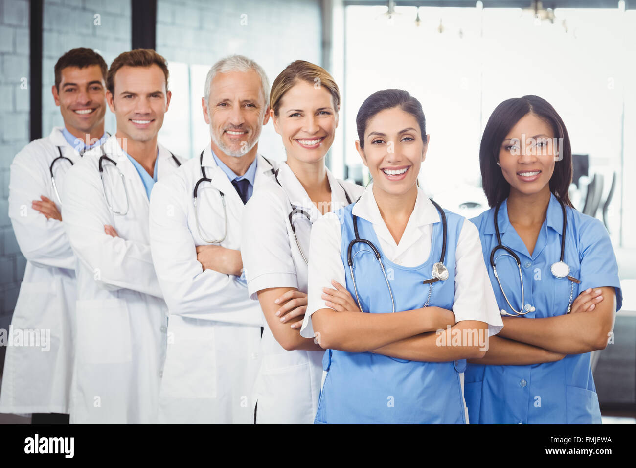 Medical team standing with arms crossed Stock Photo - Alamy