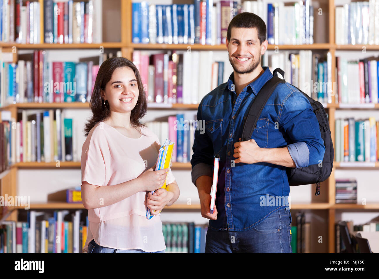 Portrait of happy smiling students at the library Stock Photo - Alamy