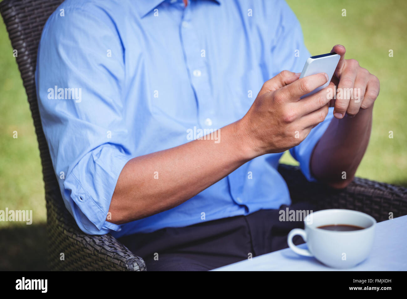 Handsome businessman texting Stock Photo - Alamy