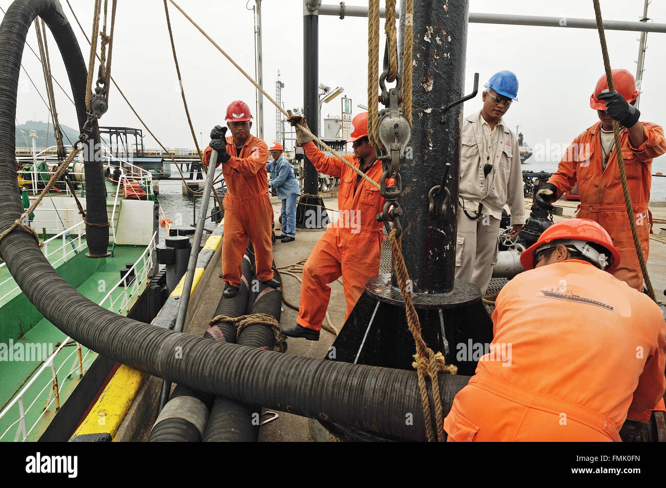 CHONBURI - OCTOBER 3: Workers preparing for loading crude oil form ship ...
