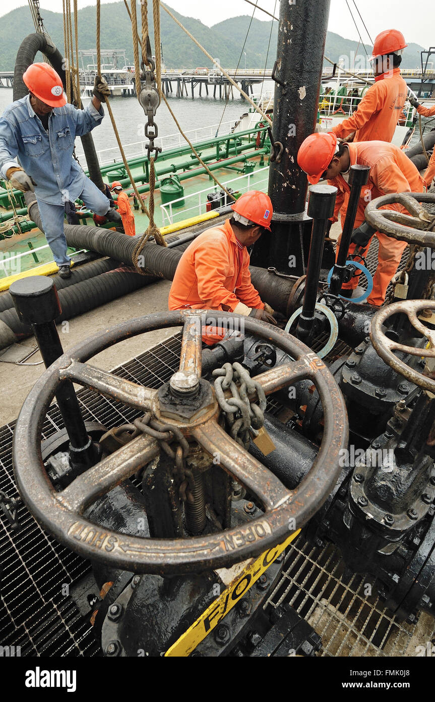 CHONBURI - OCTOBER 3: Workers preparing for loading crude oil form ship ...
