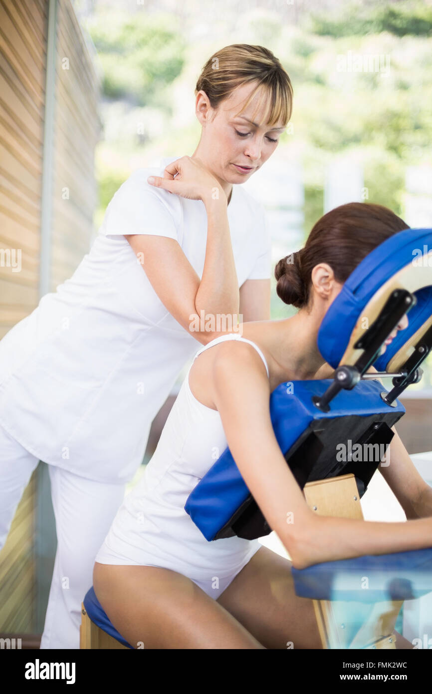 Female physiotherapist giving back massage Stock Photo - Alamy