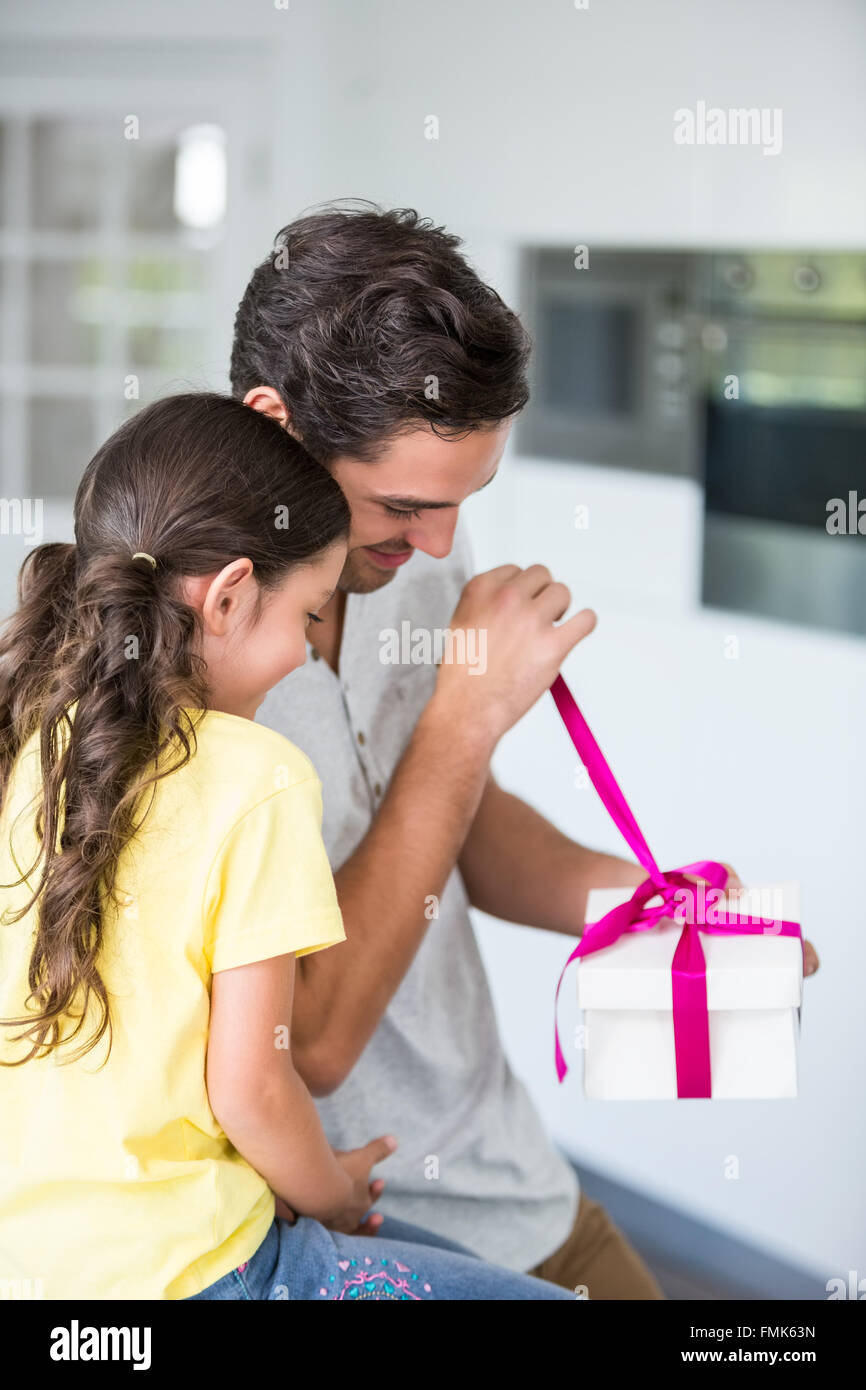 Father opening gift given by daughter Stock Photo - Alamy