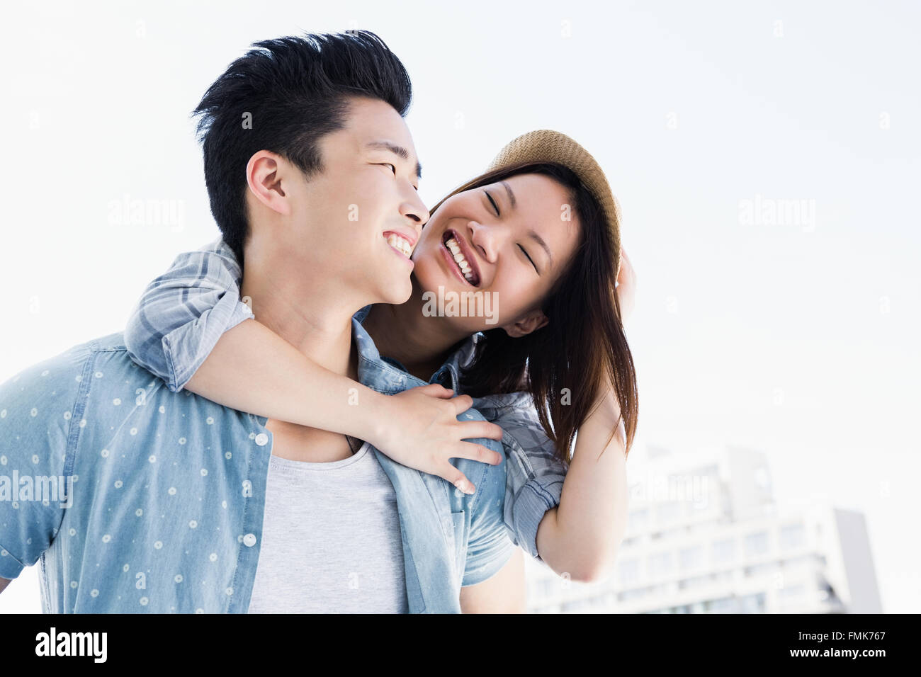 Young man giving a piggyback ride to woman Stock Photo - Alamy