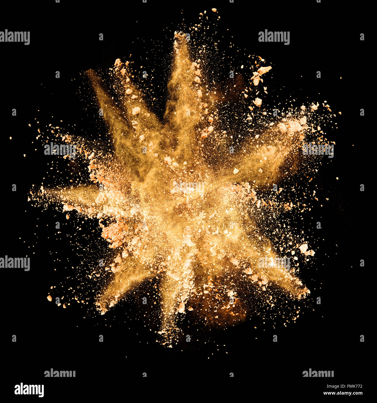 Explosion of brown powder on black background Stock Photo - Alamy
