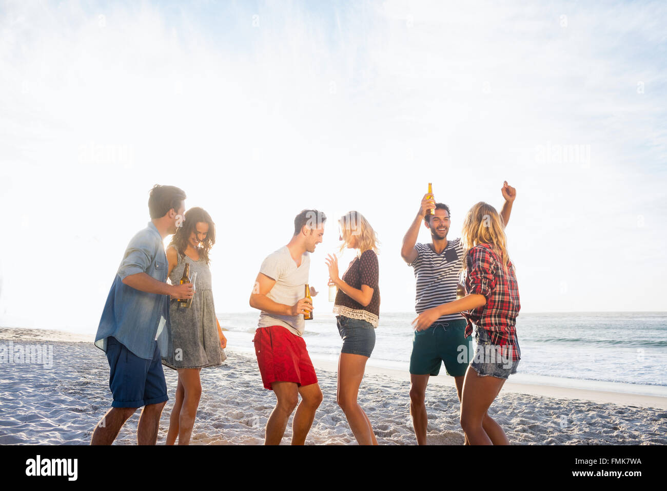 Happy friends dancing together Stock Photo - Alamy
