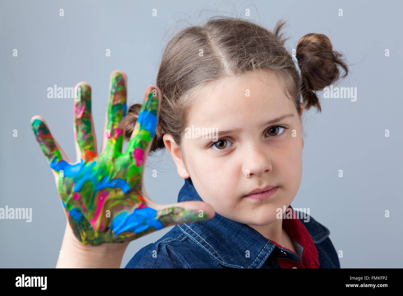Beautiful little girl with painted hand against grey background Stock ...